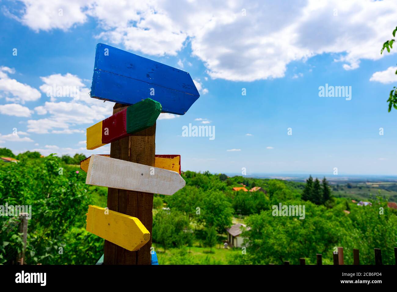 Wooden colorful arrow shape signs, points the way to the different ...