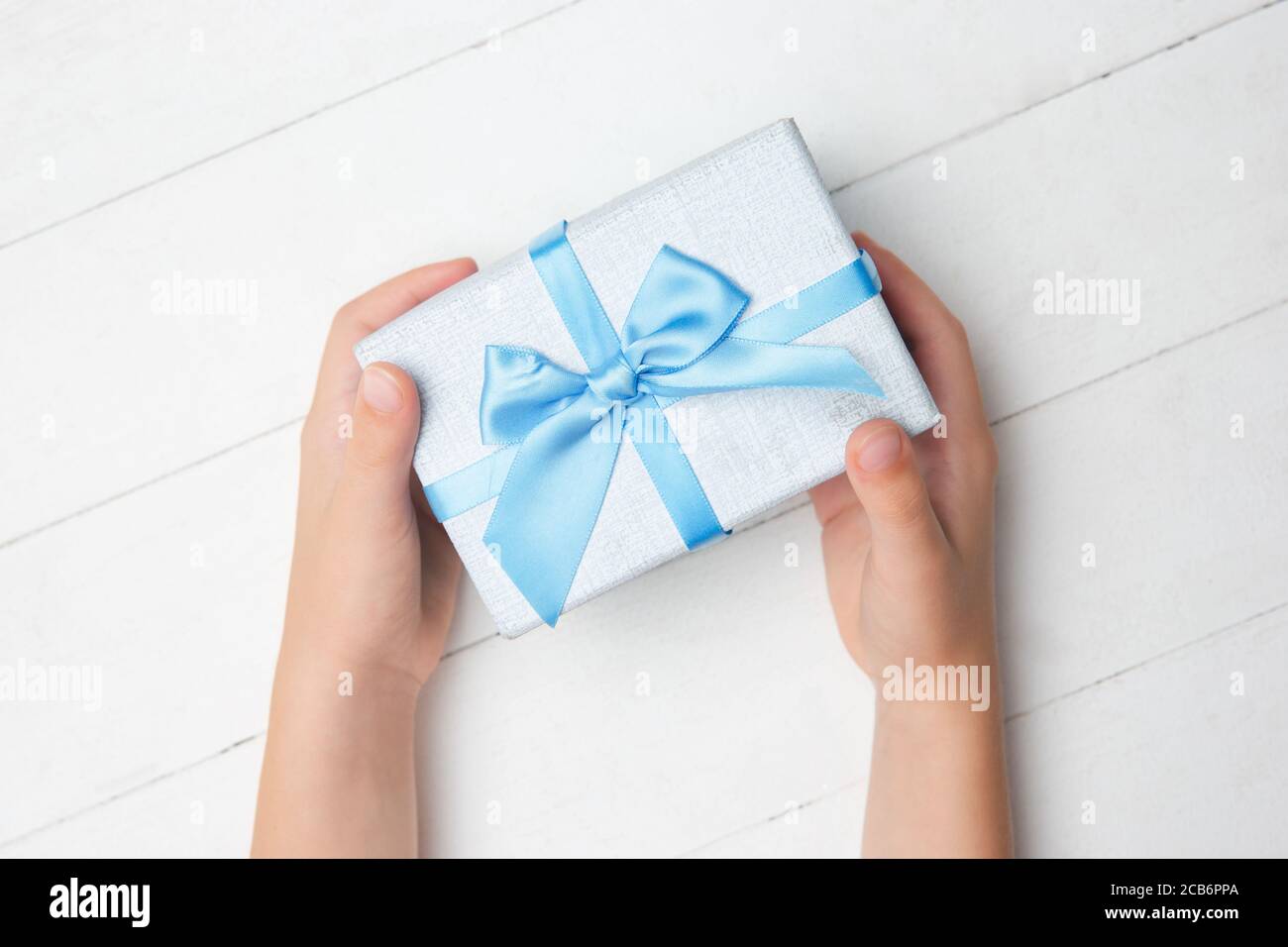 Human's hand holding a present, gift, surprise box isolated on white ...