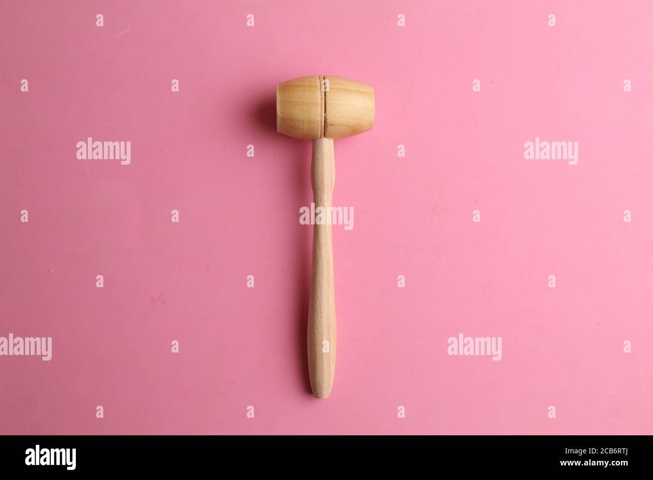 Overhead shot of a wooden hammer isolated on a pink background Stock ...
