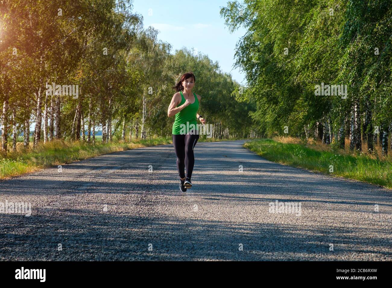 Caucasian woman jogging on country road hi-res stock photography and ...