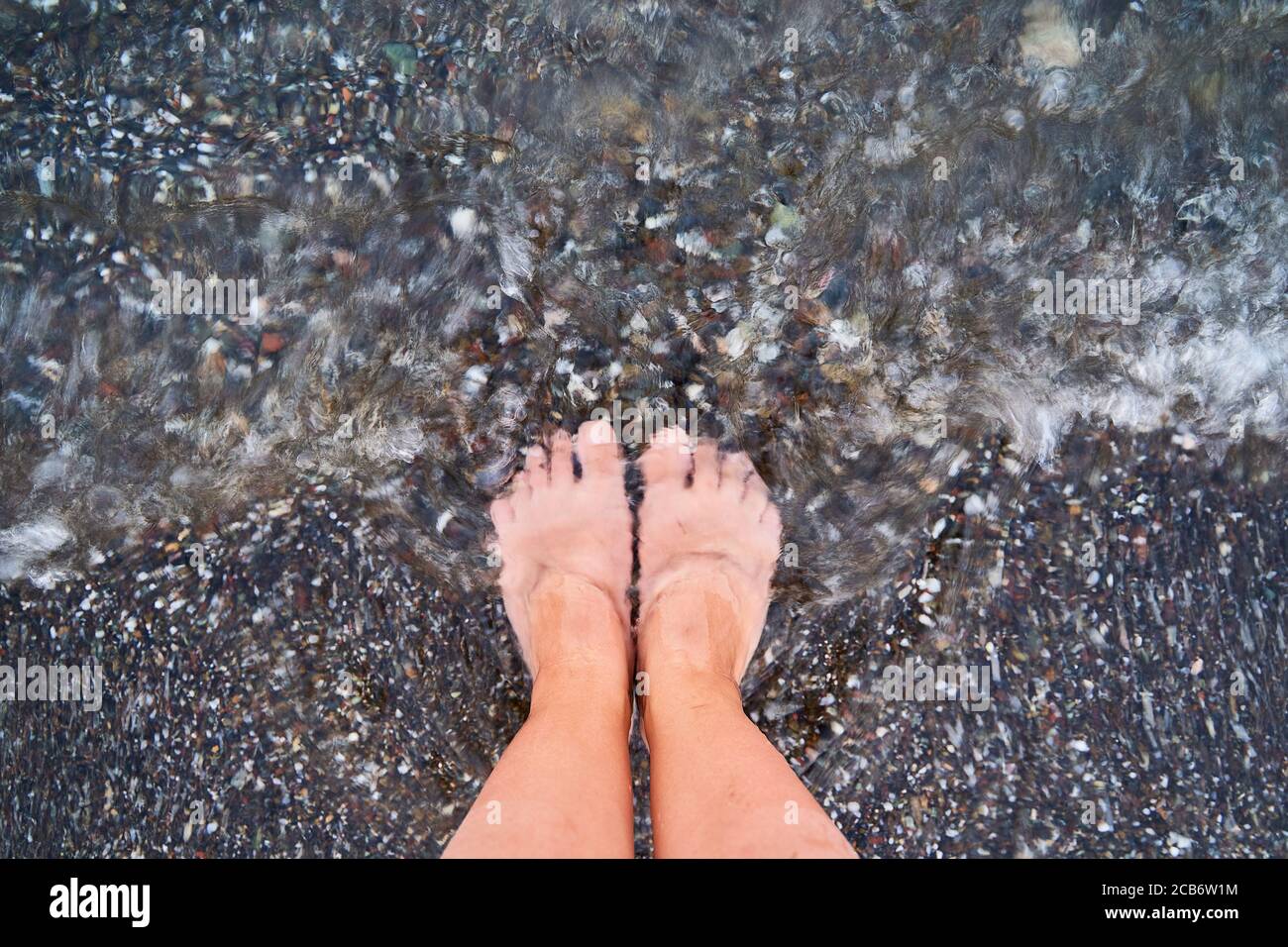 Top view of feet at the beach with sea waves. Grounding concept ...