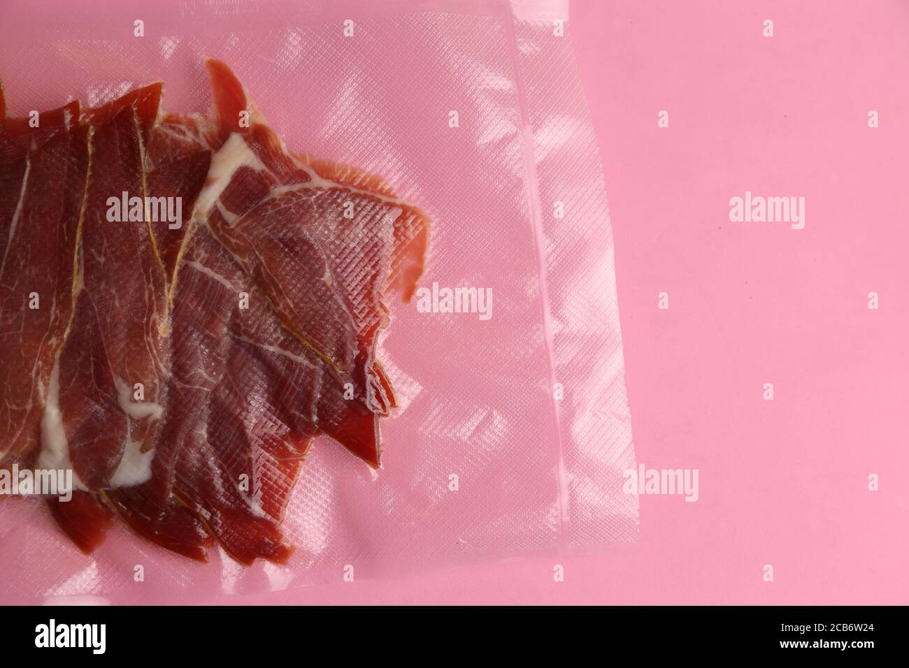 Raw meat slices in a vacuum package on a pink surface Stock Photo - Alamy