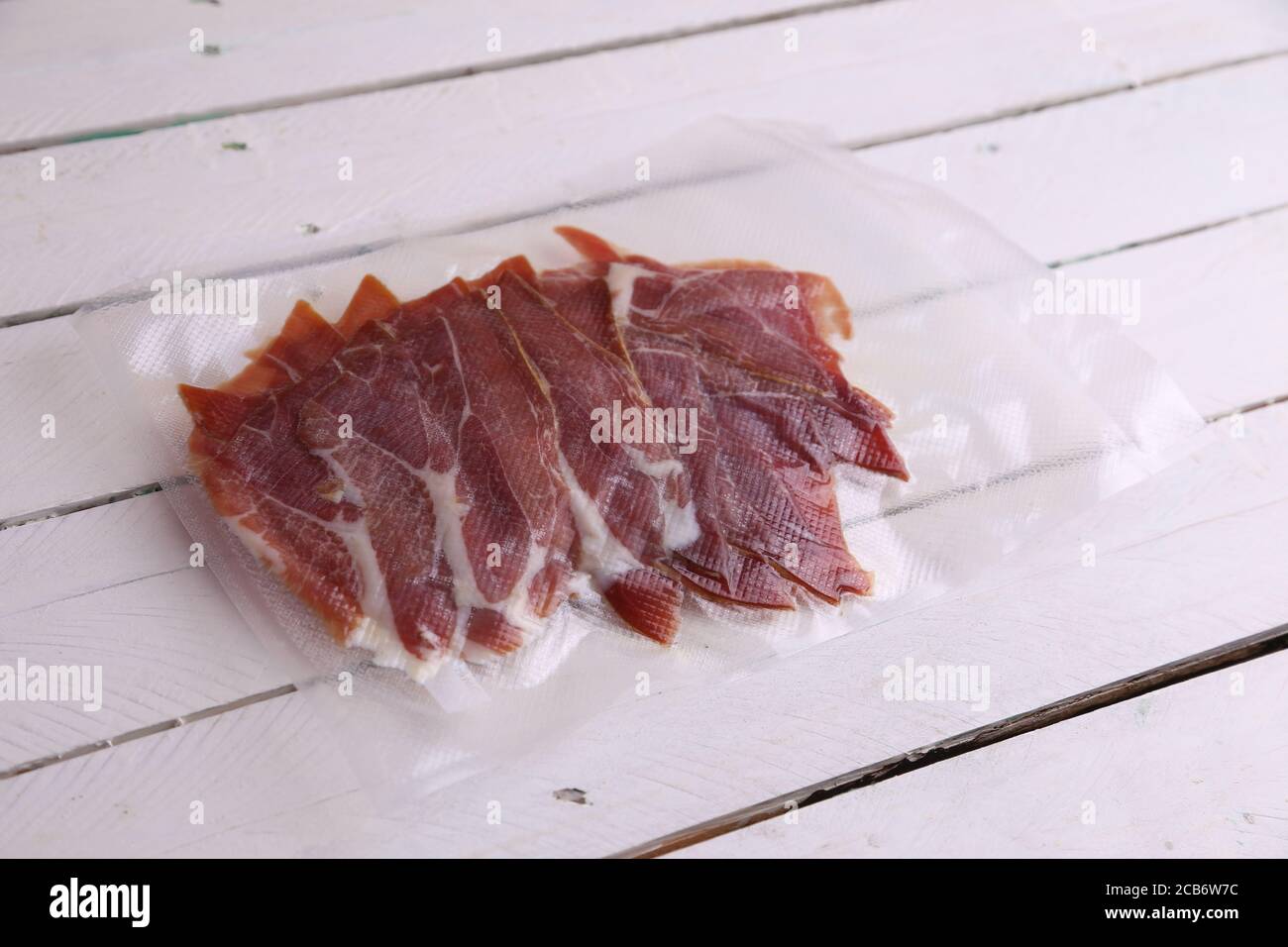 Delicious sliced Spanish dry-cured Jamon ham Stock Photo - Alamy