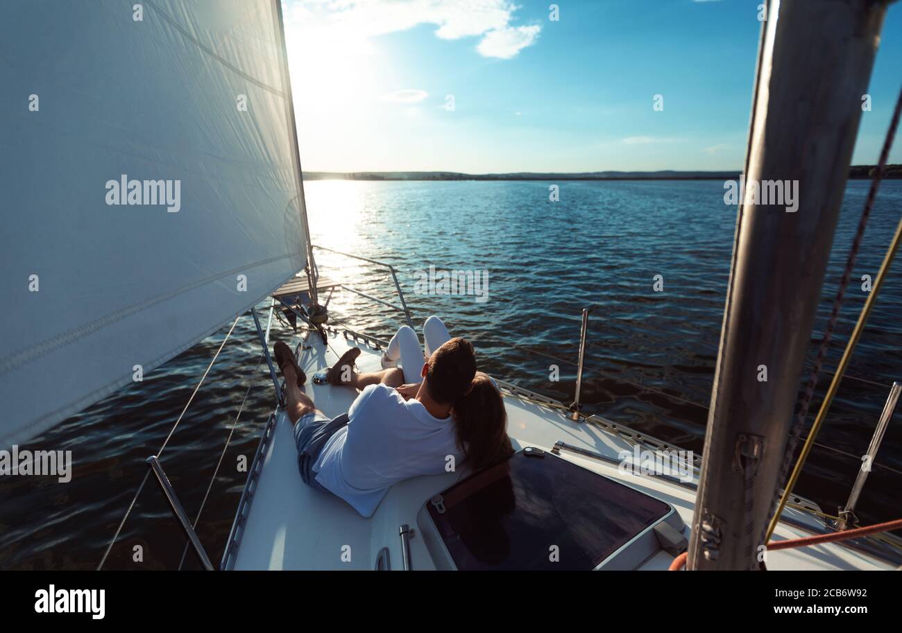 Couple Relaxing On Yacht Lying On Deck Outdoor, Back View Stock Photo ...