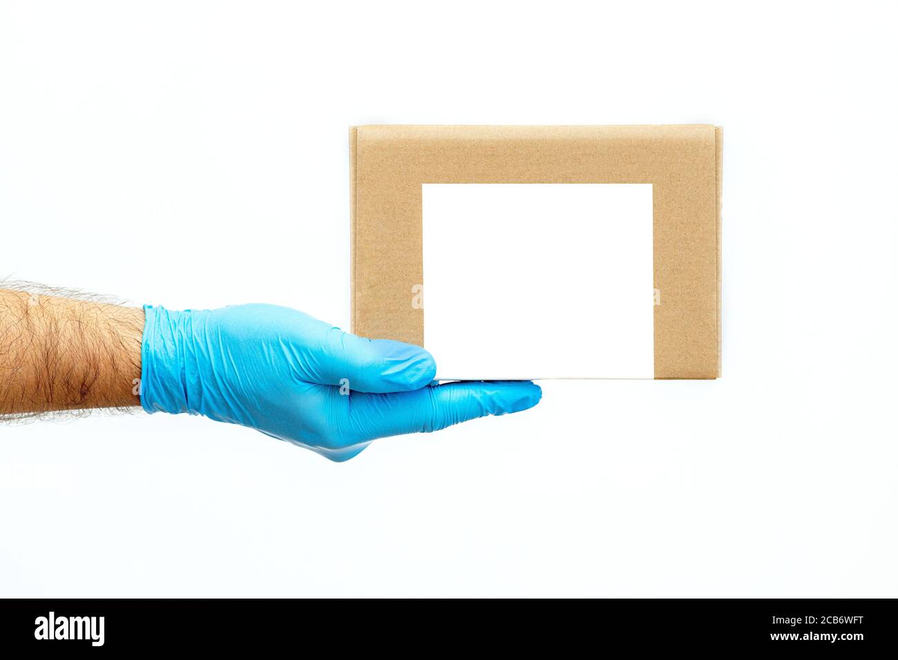 Men's hand holding cardboard boxes. Delivery by courier in medical ...