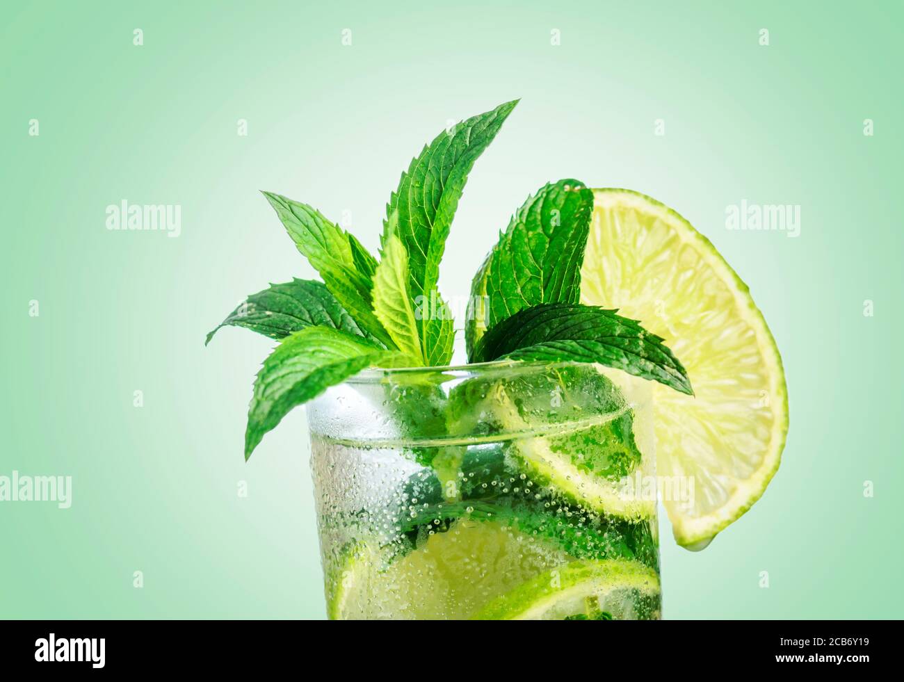 Closeup mojito cocktail with ice isolated over pastel background. Fresh ...