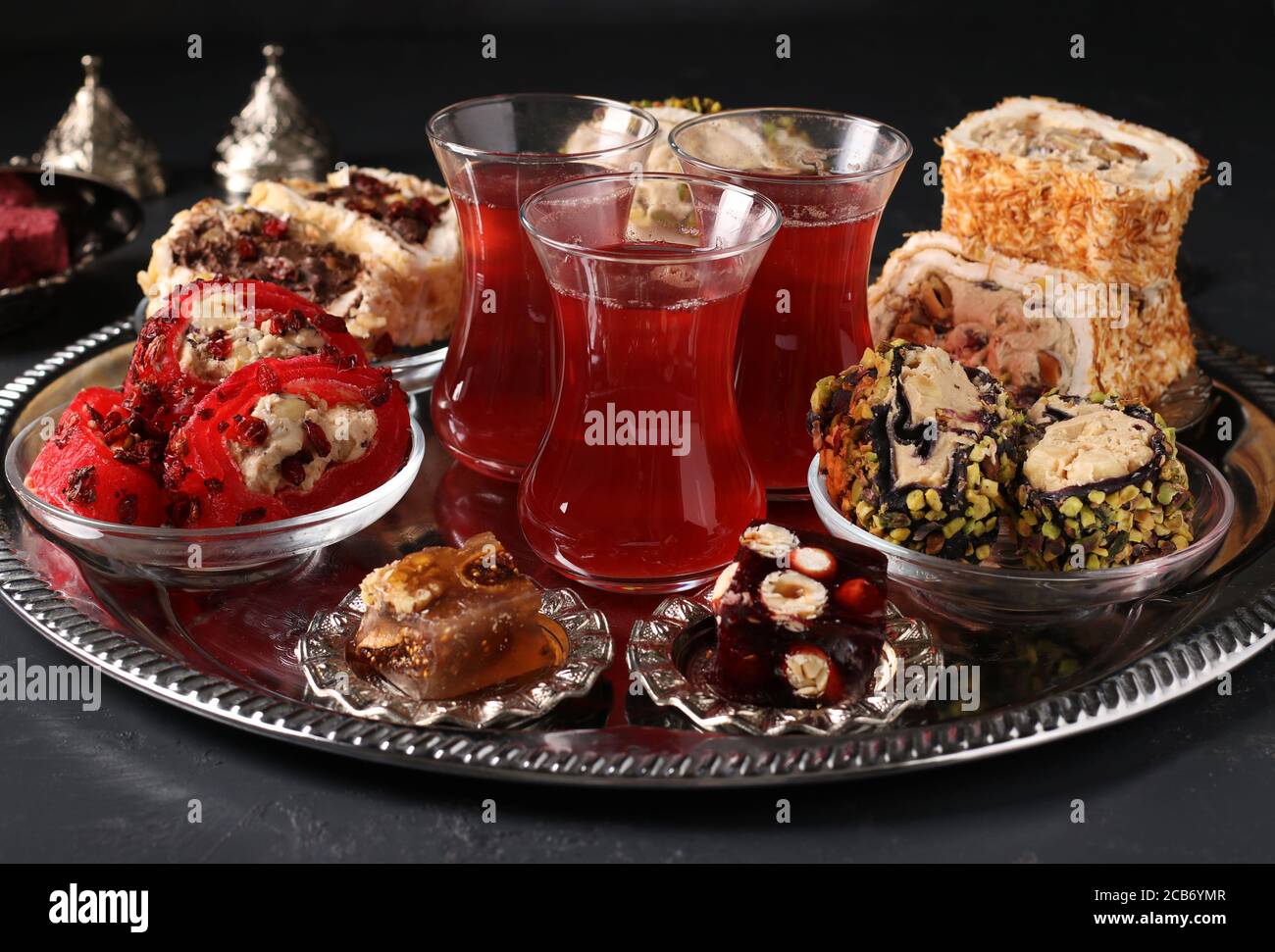 Turkish delight and pomegranate tea on metal tray on dark background ...