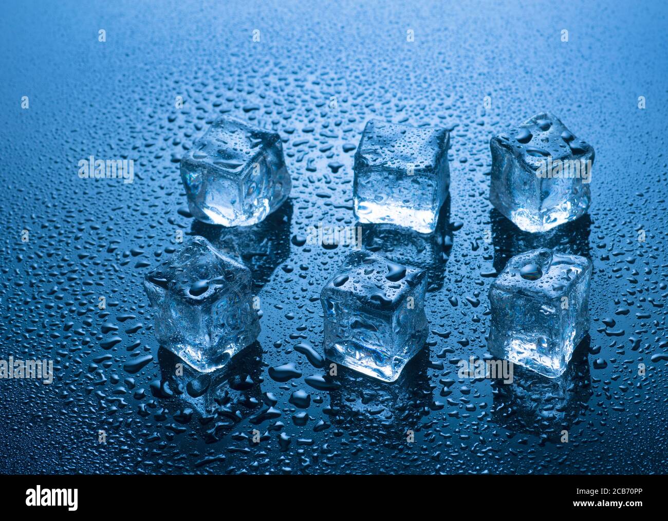 Wet Ice cubes with water drops on blue background Stock Photo - Alamy