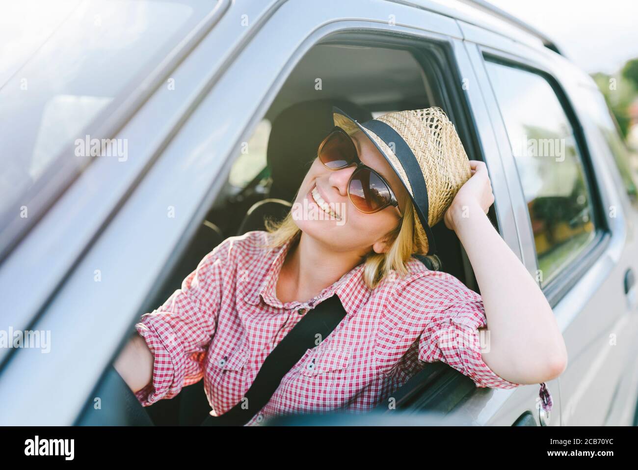 Happy woman travel by car in countryside. Summer vacation in country ...