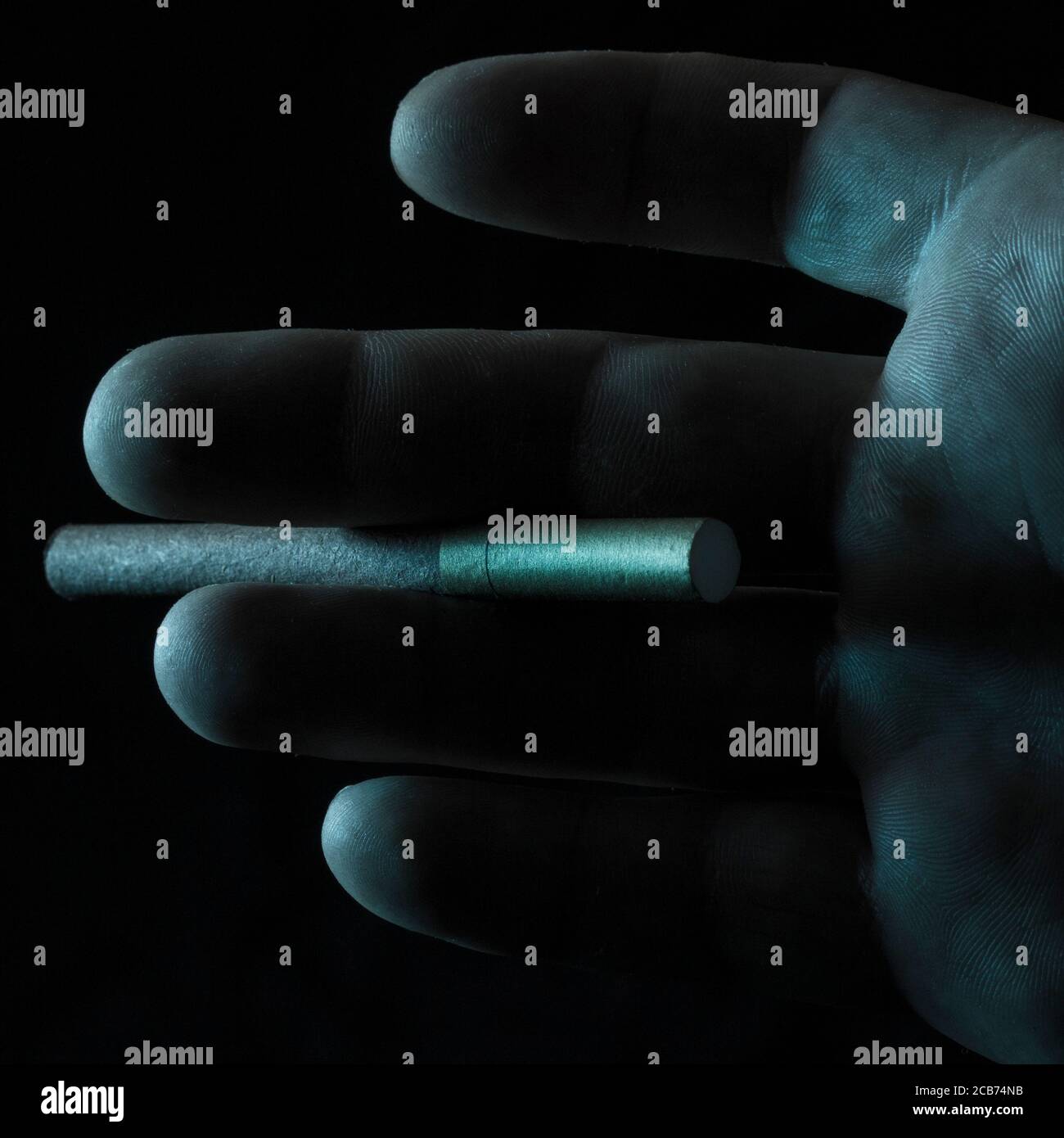 poison in his hand is a cigarette on a dark background concept of ...