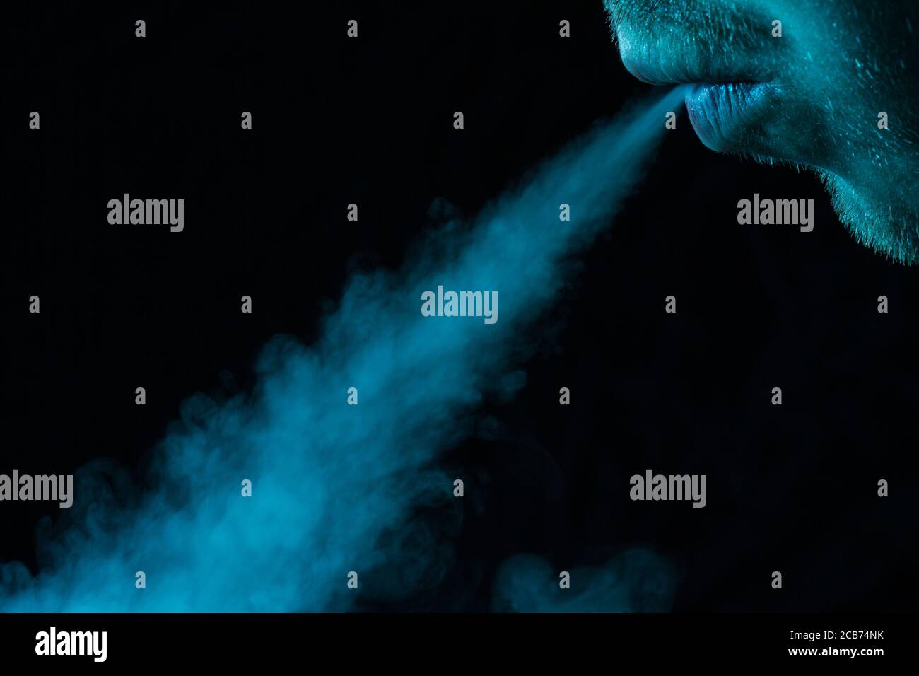 cigarette smoke comes from the mouth on a dark background concept of ...