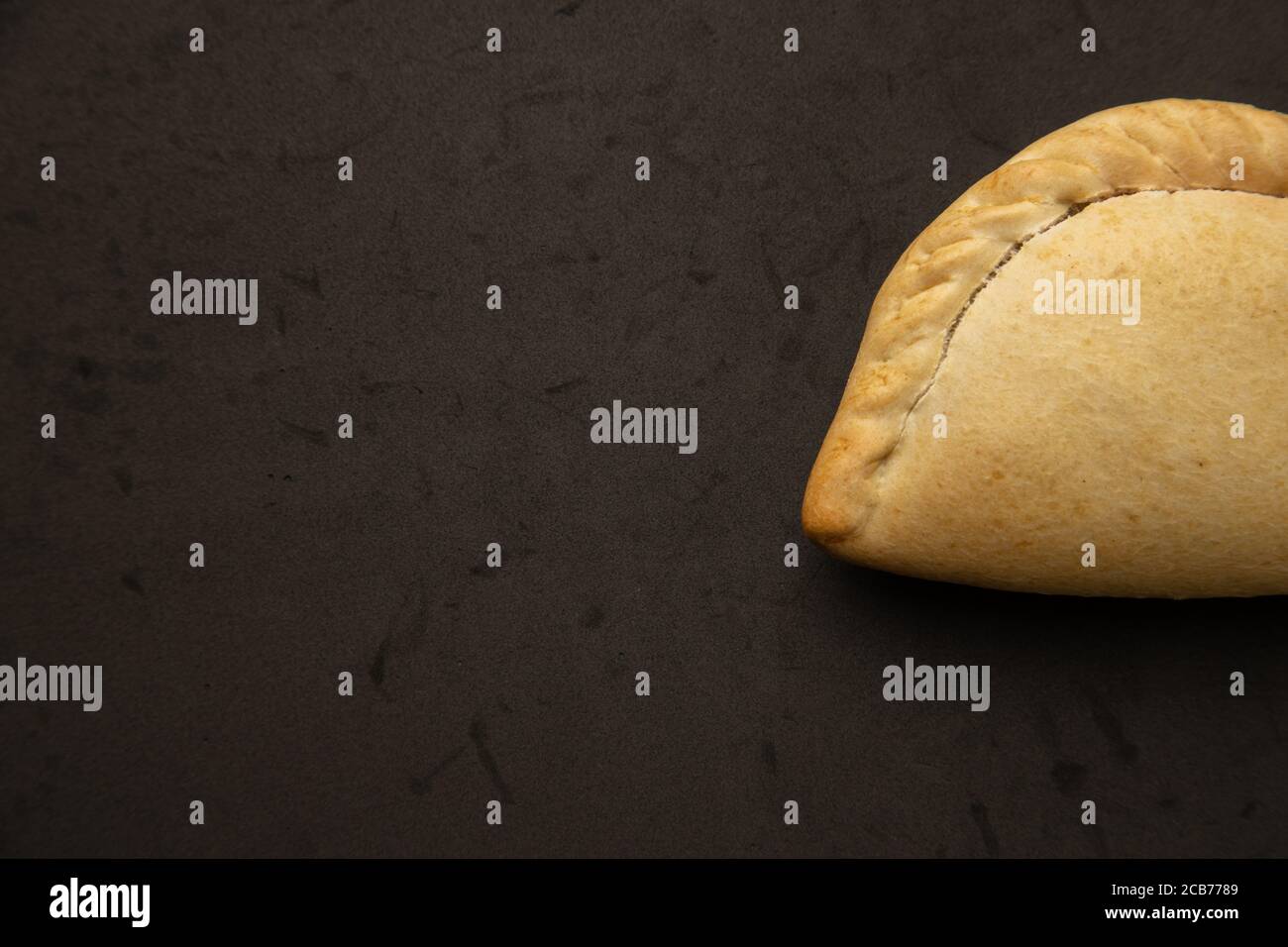 Top view of an Empanada on a brown surface under the lights Stock Photo ...