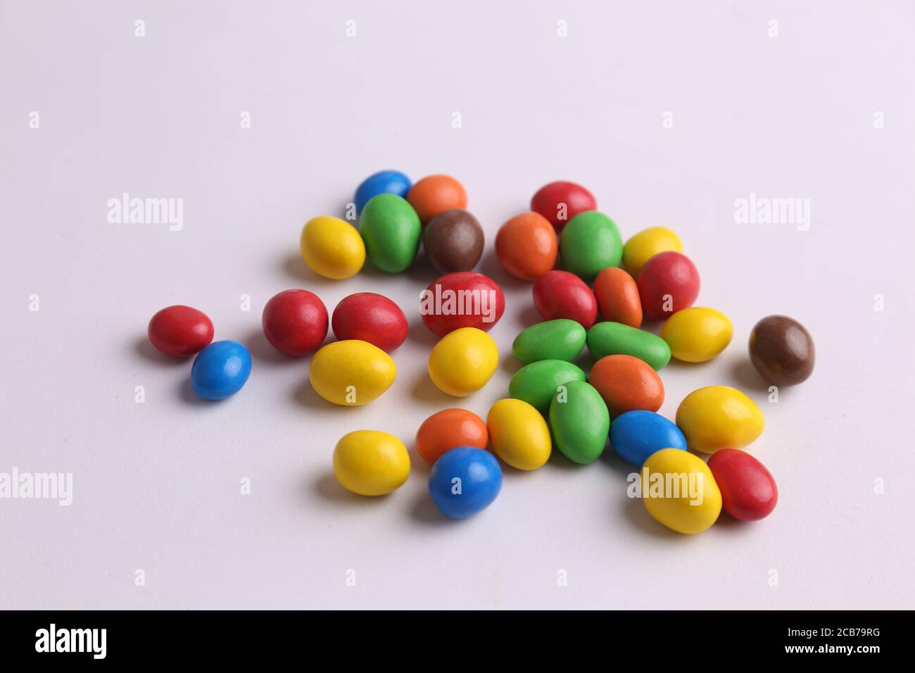 Multi colored button shaped chocolates hi-res stock photography and ...