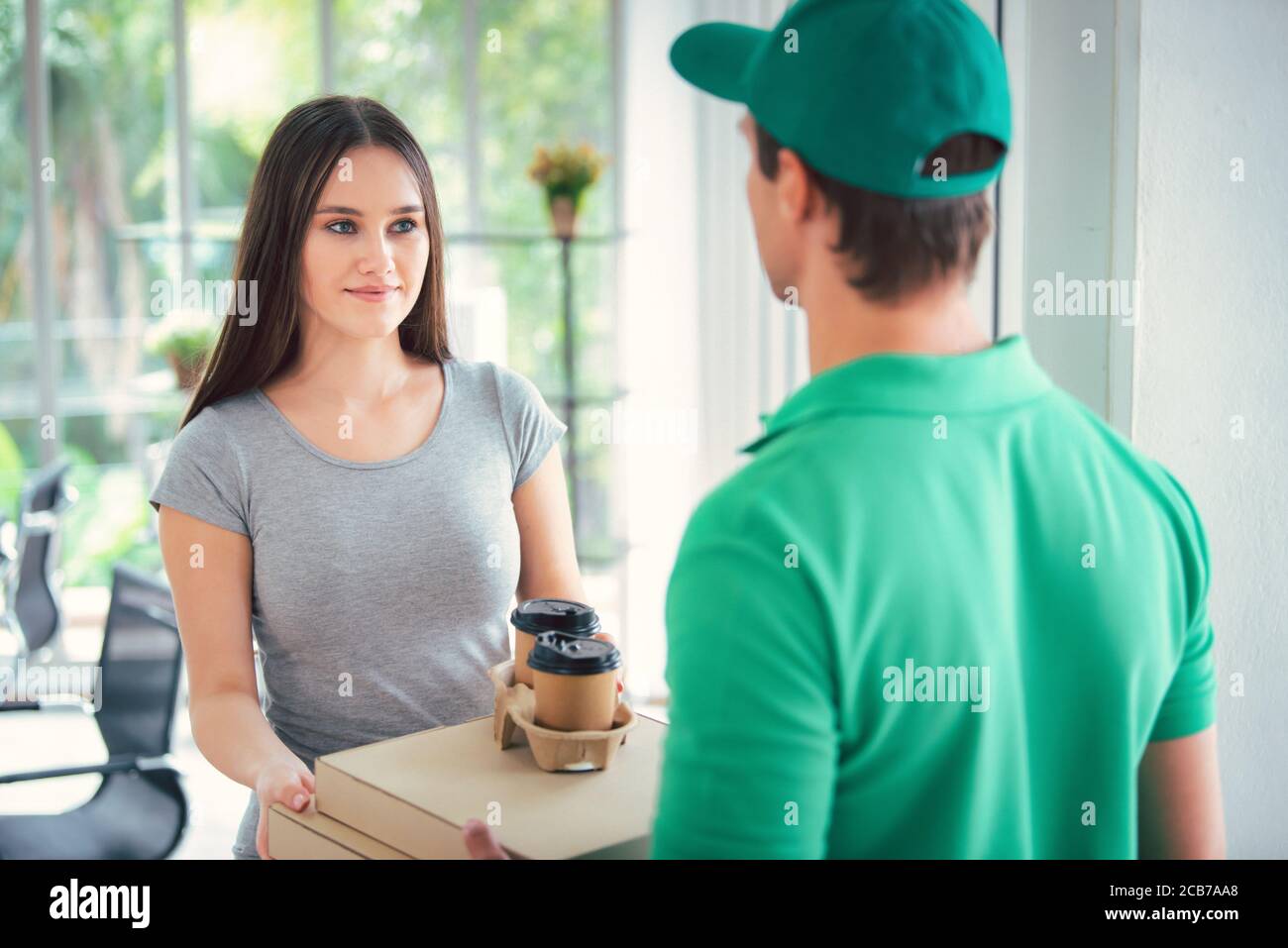 Delivery man employee in green cap t-shirt ready to send delivery food ...