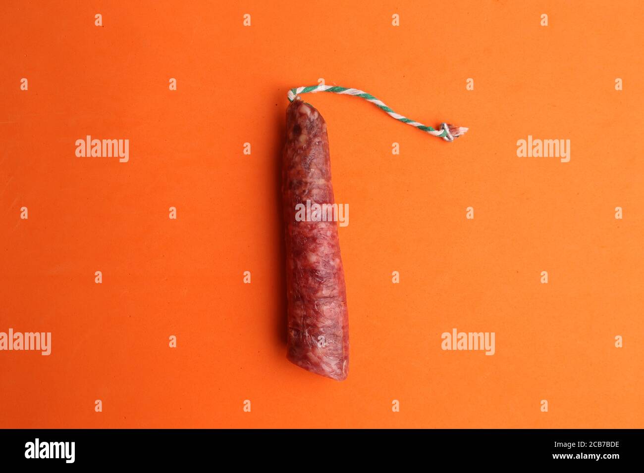 Top view of a delicious traditional sausage isolated on an orange ...