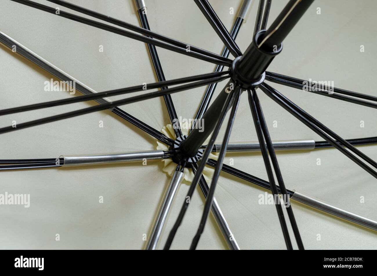Details of the inside of the umbrella. Close-up of a beige umbrella ...