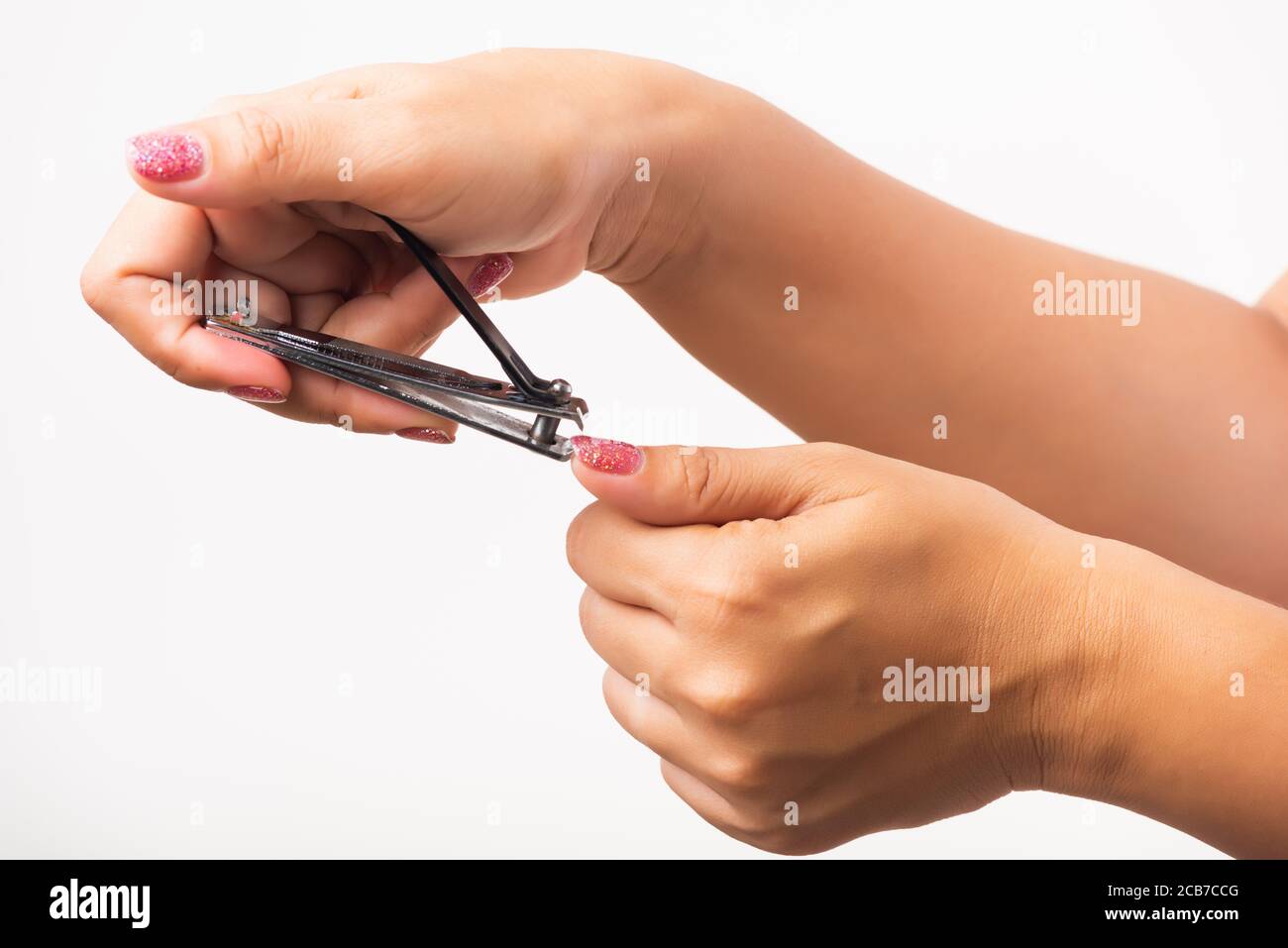 Close up young Asian woman have tool cutting nails fingernails on ...
