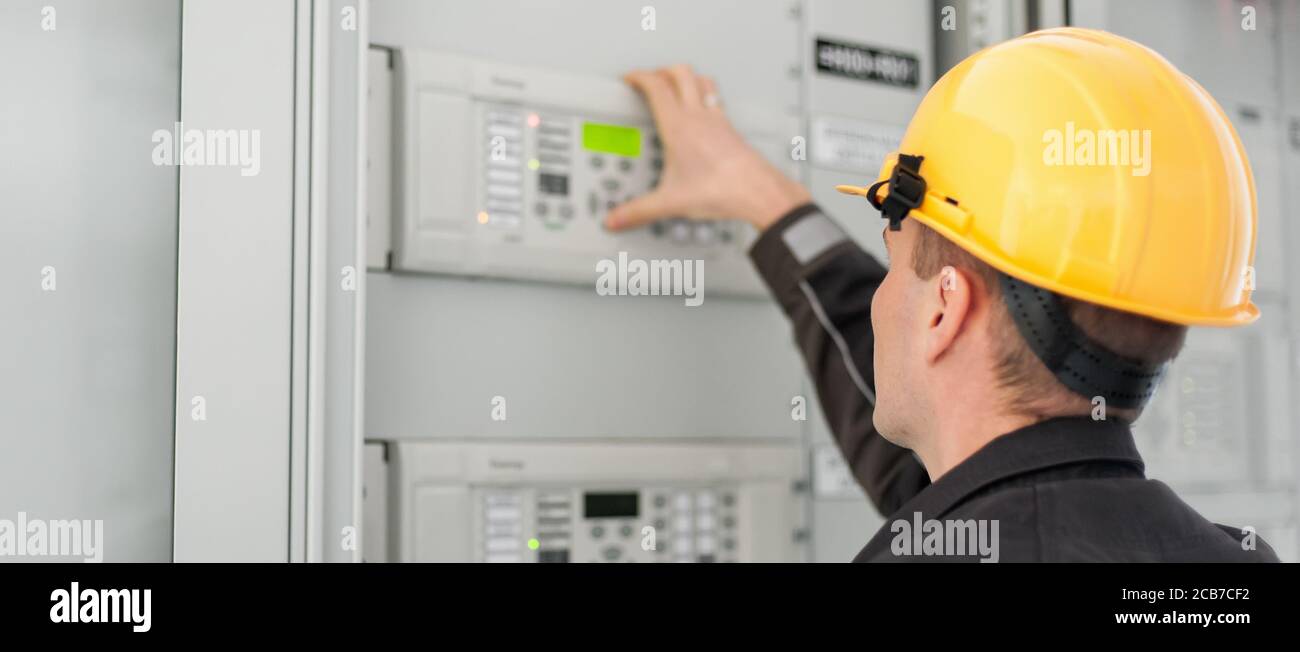 Close up of maintenance engineer testing medium voltage switchgear and ...