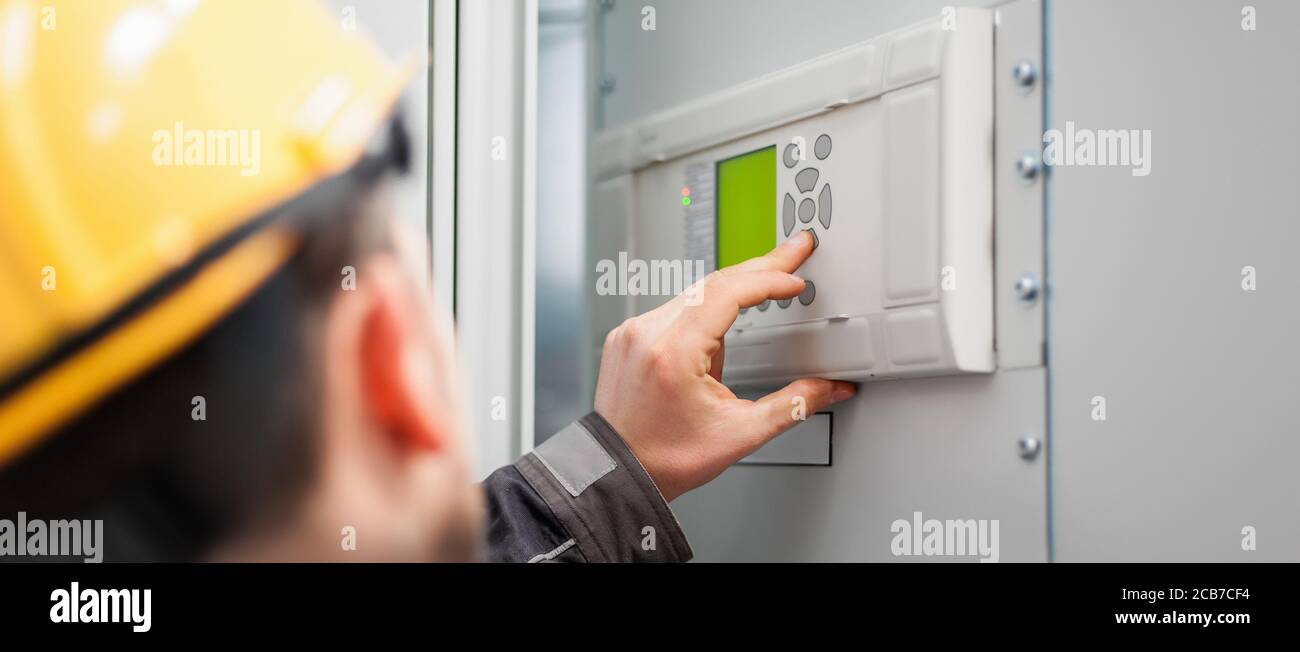 Close up of maintenance engineer testing medium voltage switchgear and ...