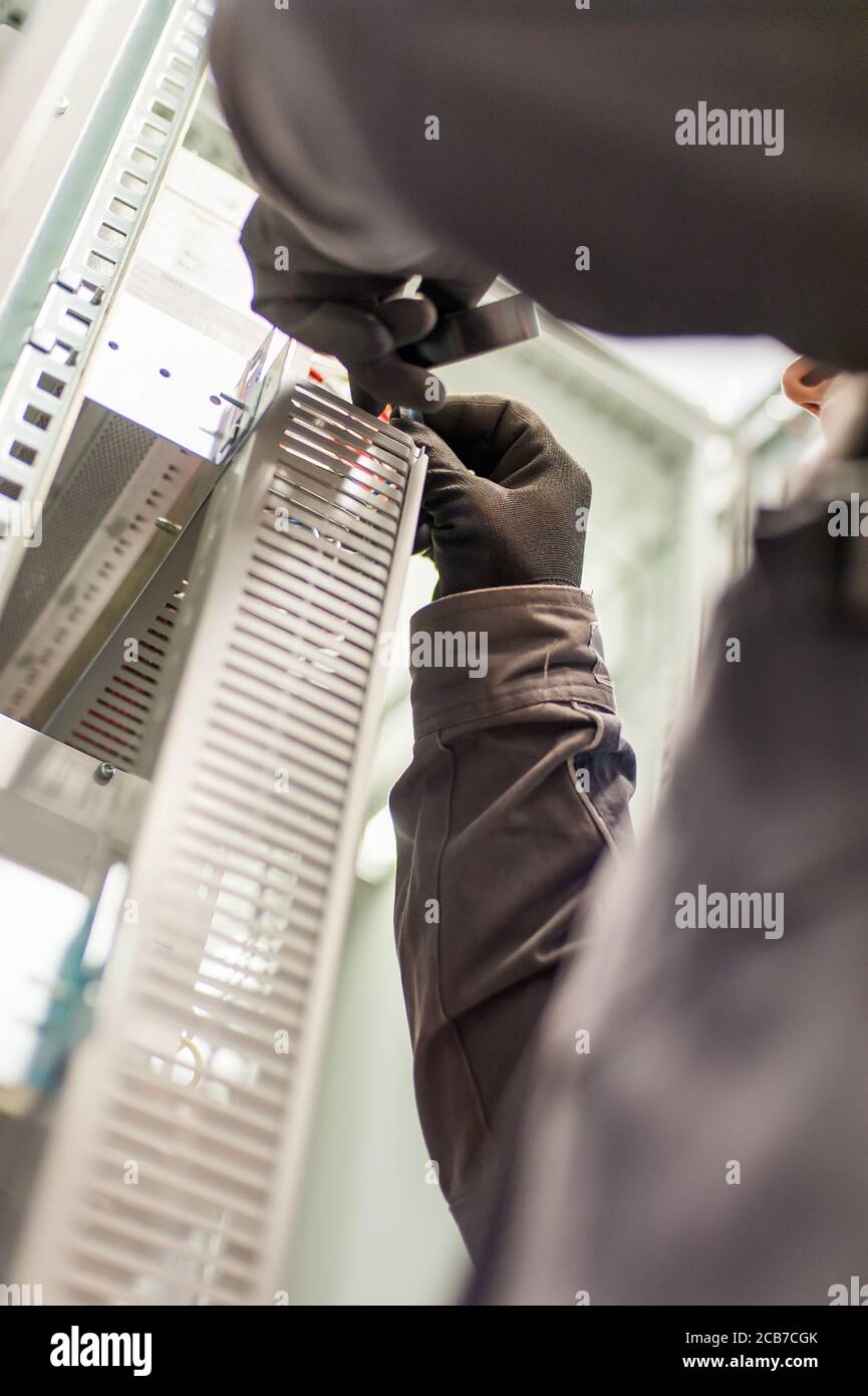 Electrician engineer tests electrical installations and wires on relay ...