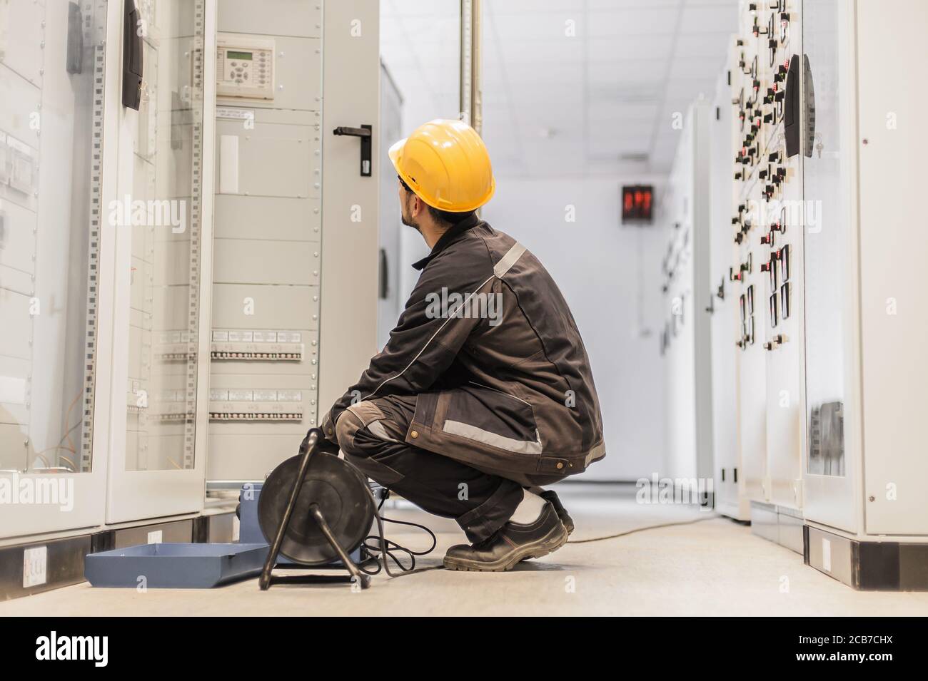 Electrician engineer tests system with relay test set equipment. Relay ...