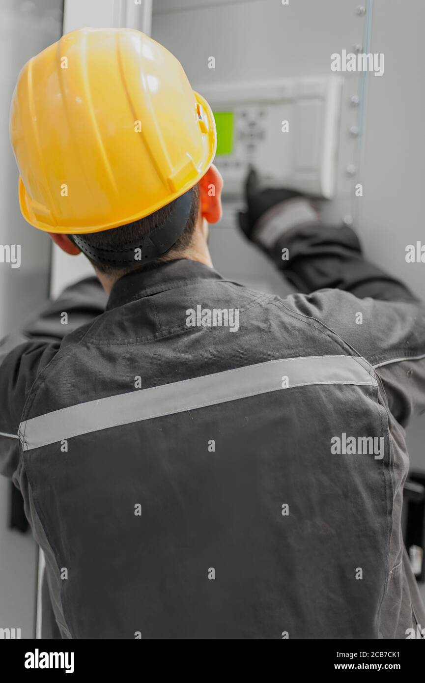 Engineer commissioning bay control unit. Engineering department. Medium ...