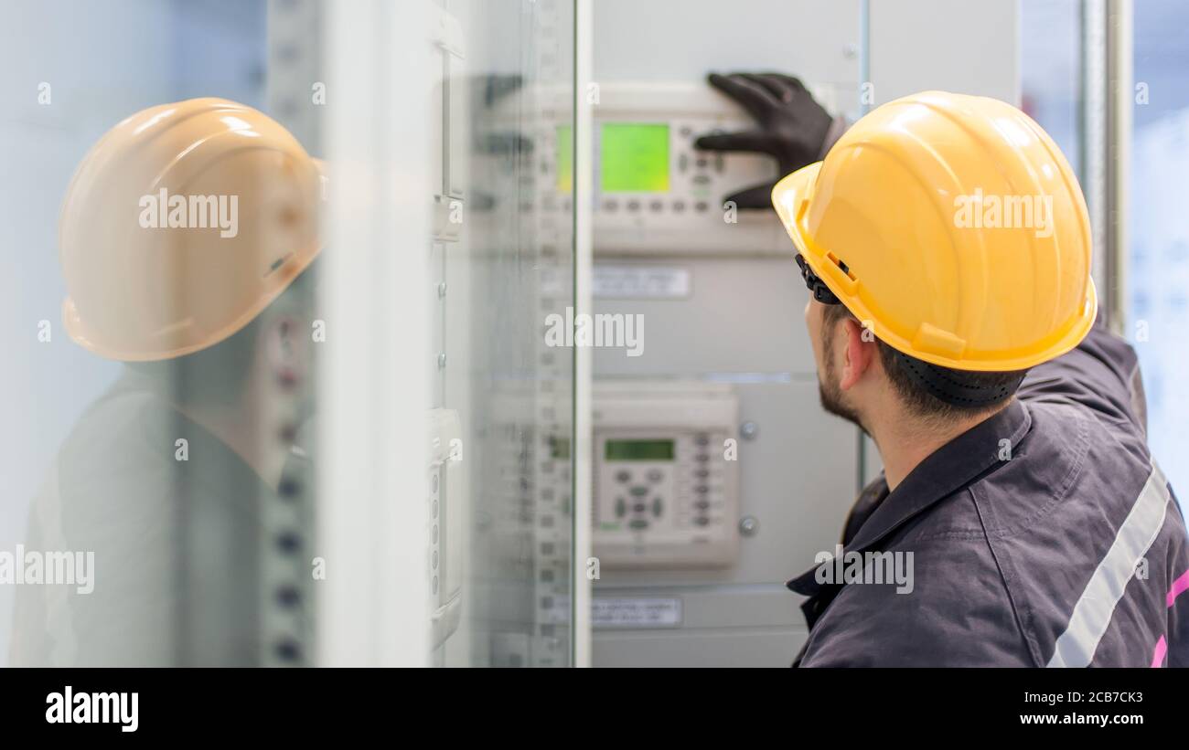 Engineer commissioning bay control unit. Engineering department. Medium ...