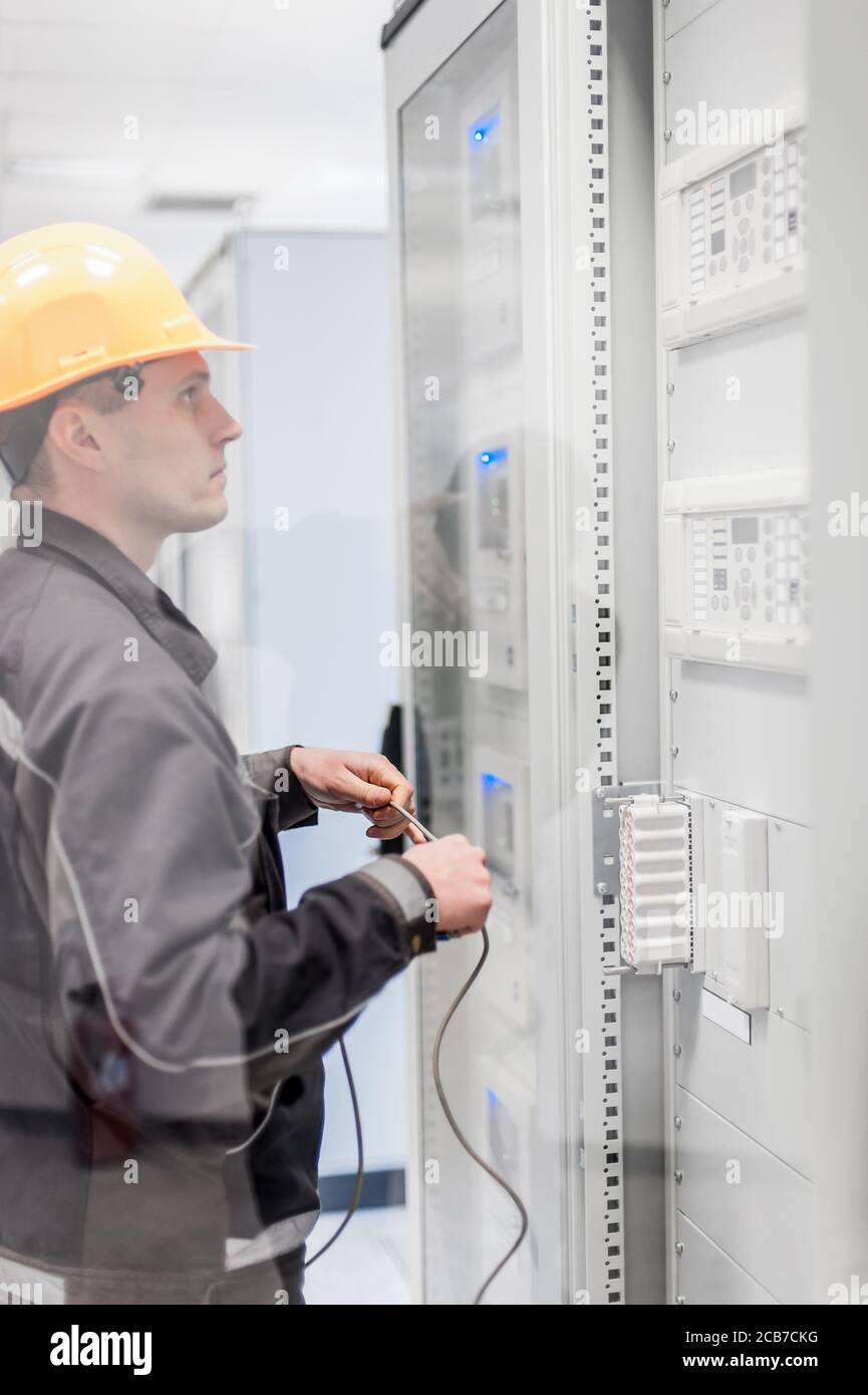 Engineer commissioning bay control unit. Engineering department. Medium ...