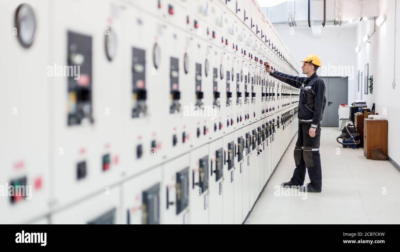 Engineer commissioning bay control unit. Engineering department. Medium ...