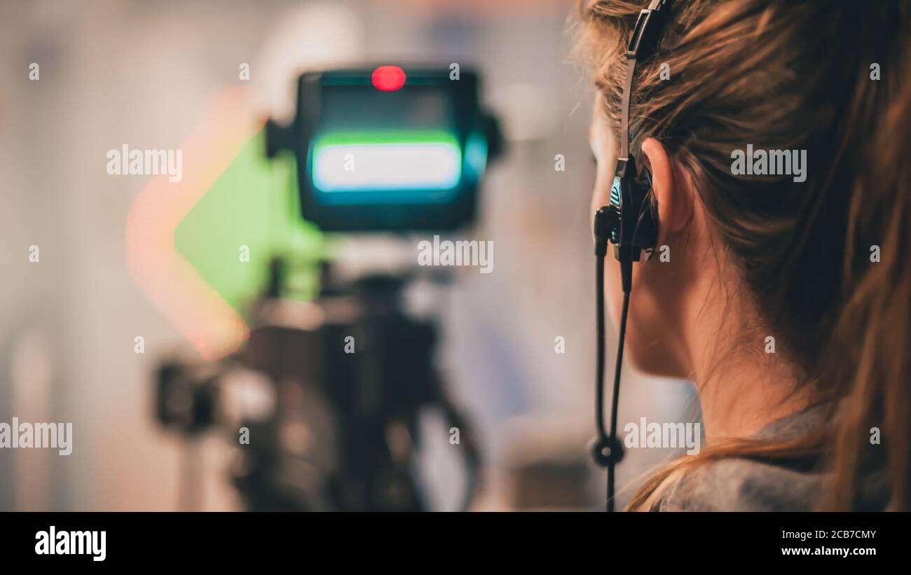 Behind the scene. Female cameraman shooting the film scene with camera ...