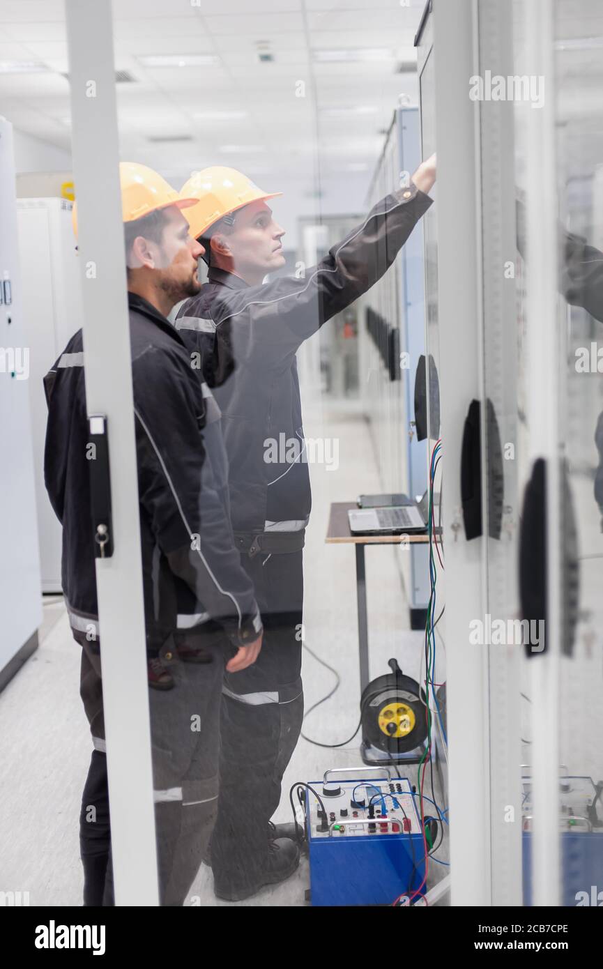 Field service crew testing electronics or inspecting electrical ...