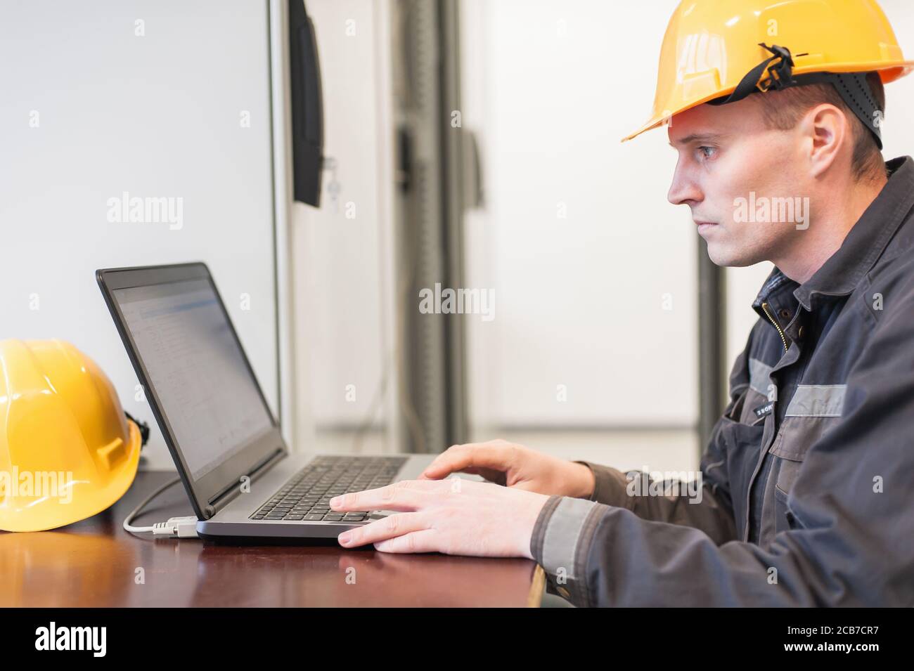 Field service engineer inspect relay protection system with laptop ...