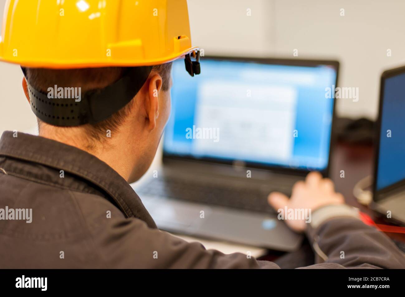 Field service engineer inspect relay protection system with laptop ...