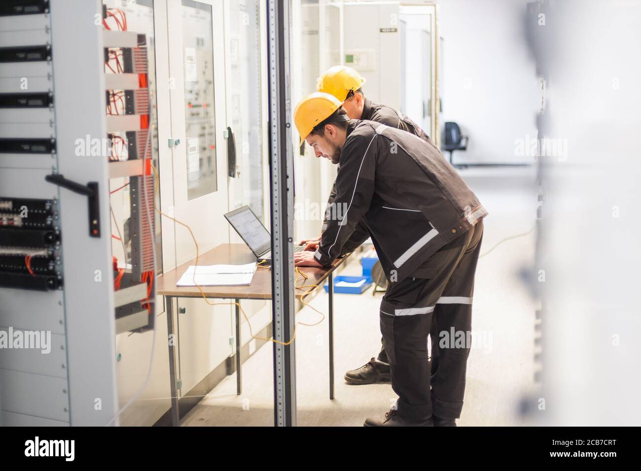 Field service crew engineers inspect relay protection system with ...