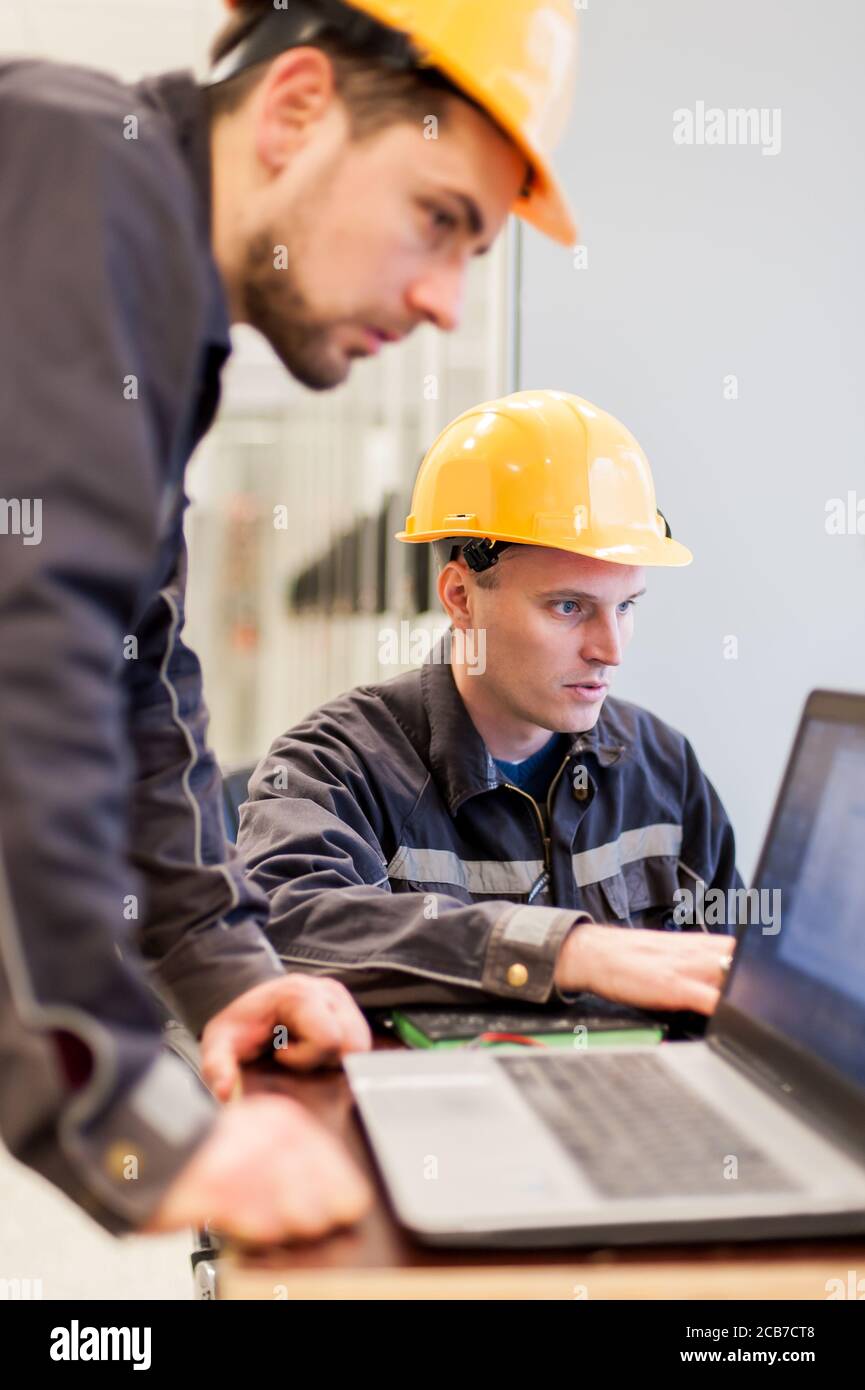 Field service crew engineers inspect relay protection system with ...