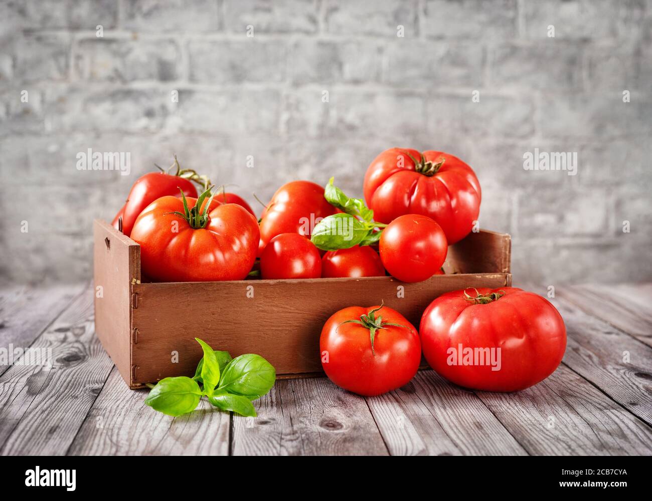 Wooden box full of ripe, red and juicy harvested tomatoes Stock Photo ...