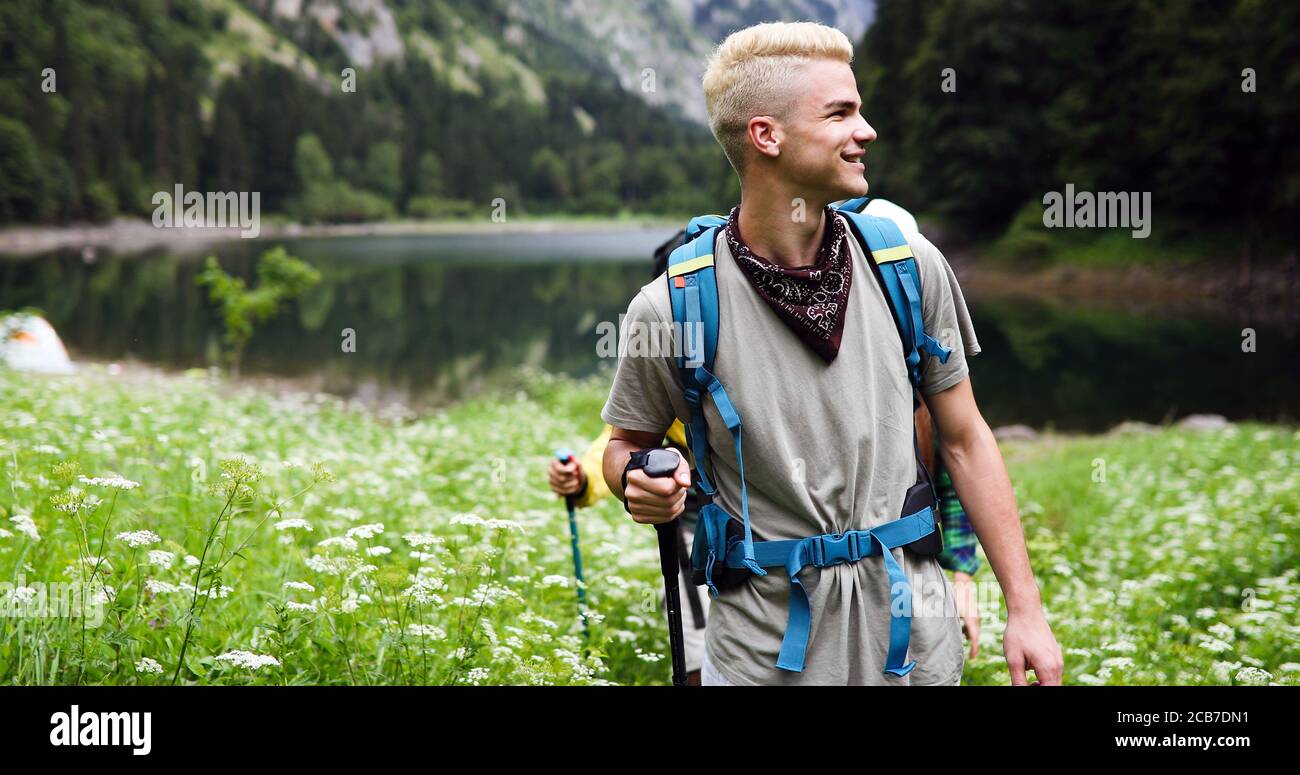 Adventure man hiking wilderness mountain with backpack Stock Photo - Alamy