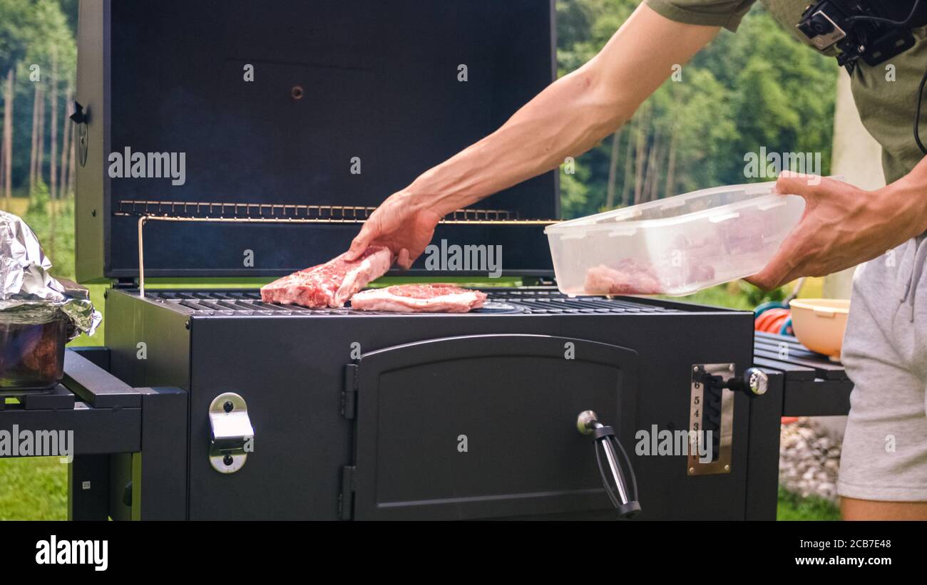 Home barbecue with charcoal in the backyard grilling steaks and other ...