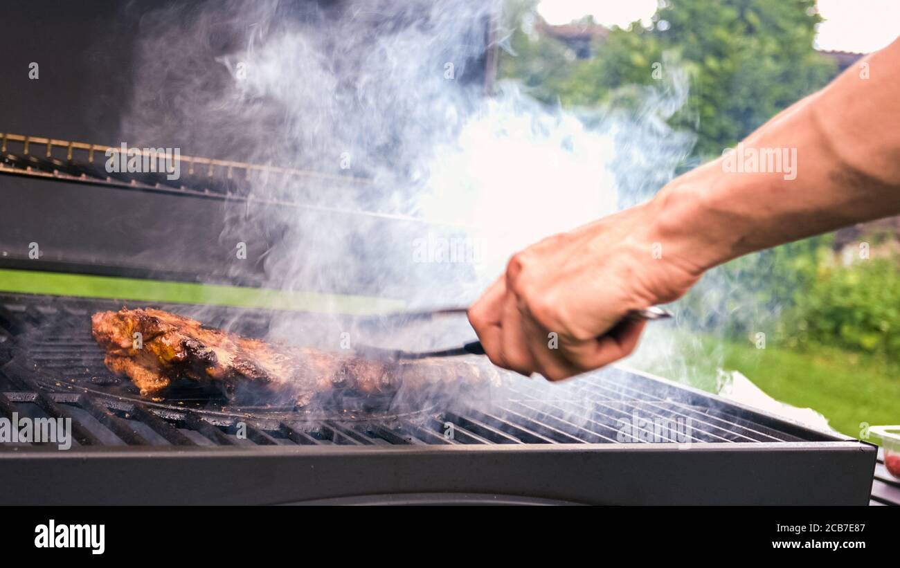 Home barbecue with charcoal in the backyard grilling steaks and other ...