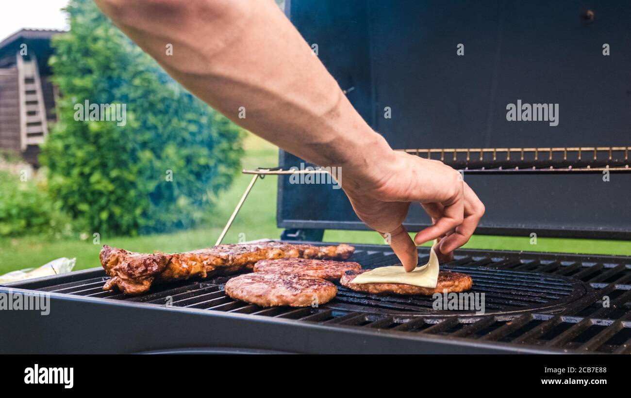 Home barbecue with charcoal in the backyard grilling steaks and other ...