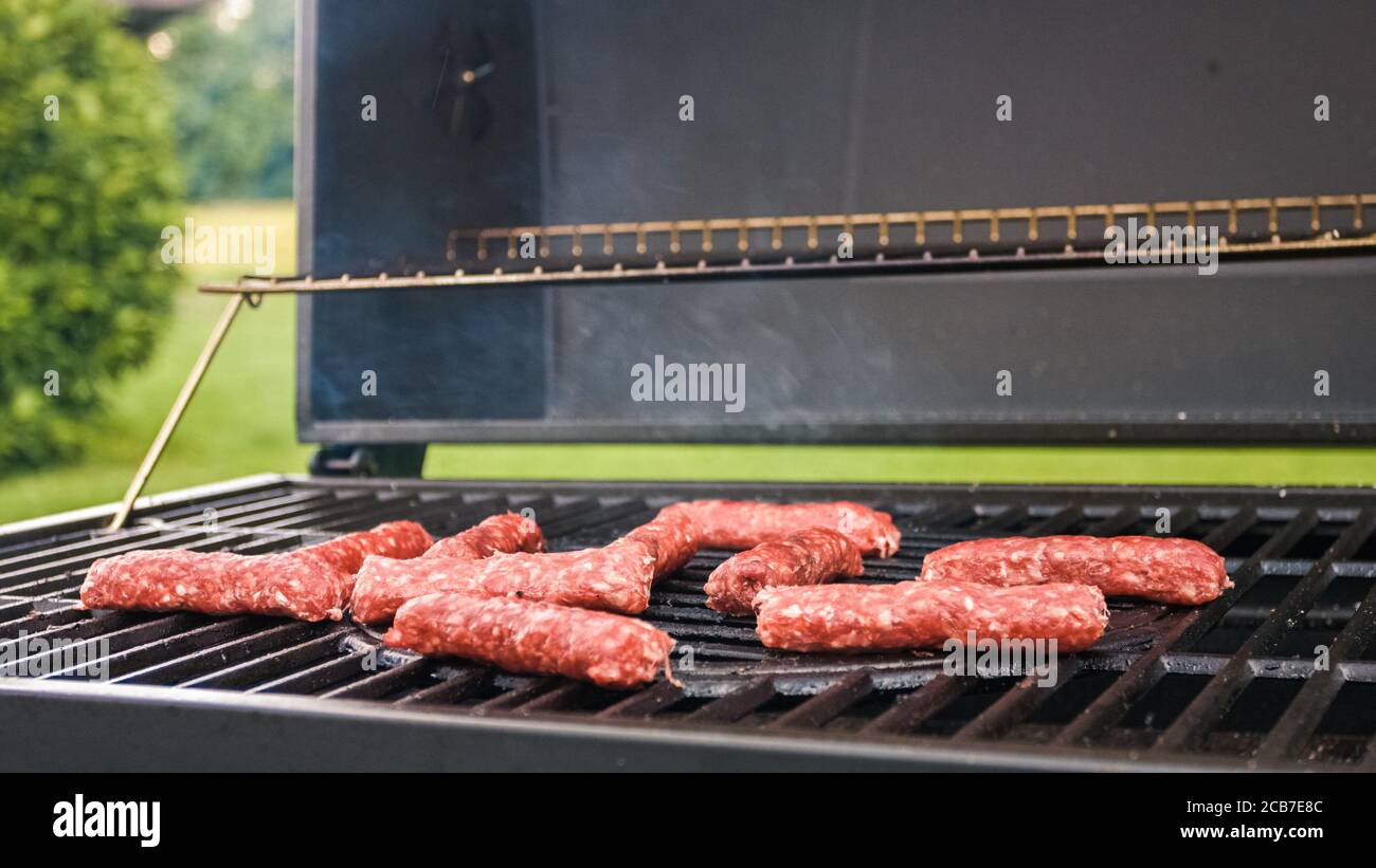 Home barbecue with charcoal in the backyard grilling steaks and other ...
