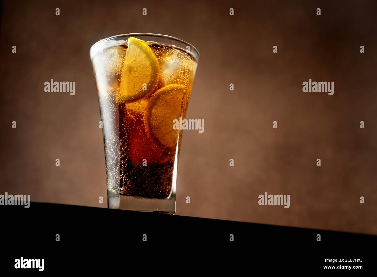Brown sweet soda iced drink on dark background Stock Photo - Alamy