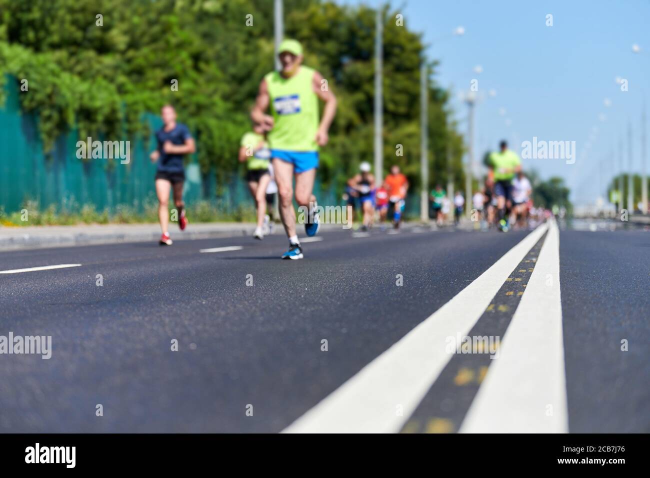 Runners on city road. Running marathon, copy space. Street sprinting ...