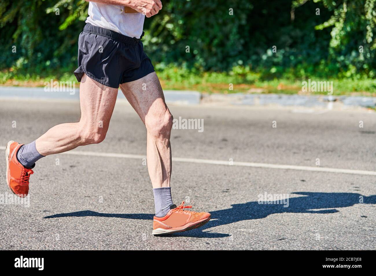 Running old man. Old man jogging in sportswear on city road. Healthy ...
