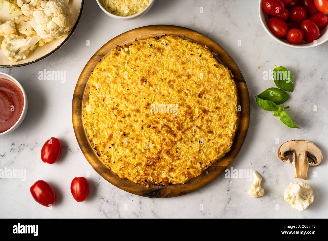 Top view of cauliflower pizza crust with ingredients Stock Photo - Alamy