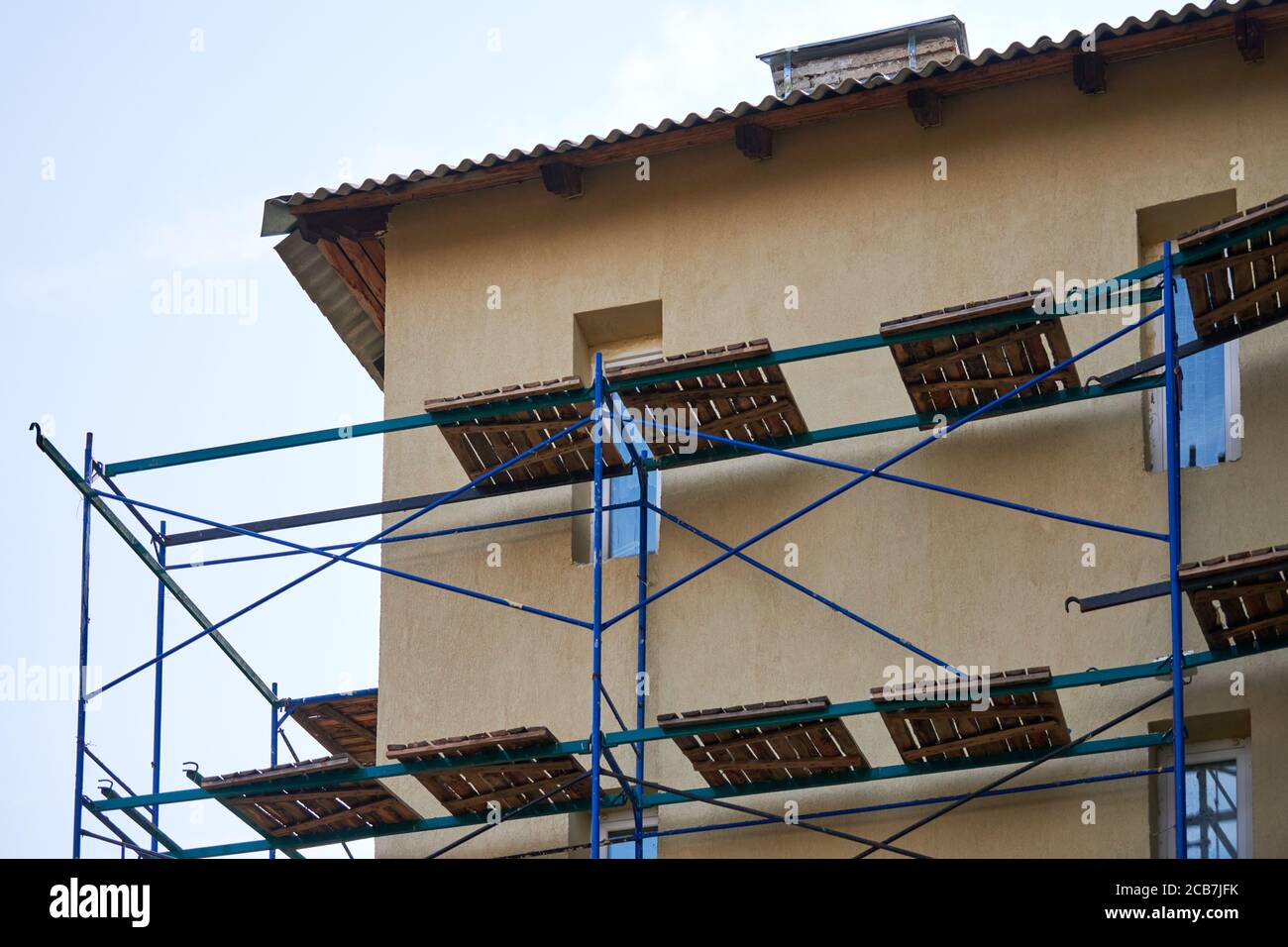 Scaffolding on construction site. Incomplete building and decoration ...
