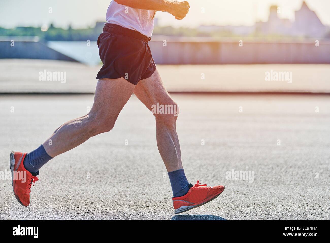 Running old man. Old man jogging in sportswear on city road. Healthy ...