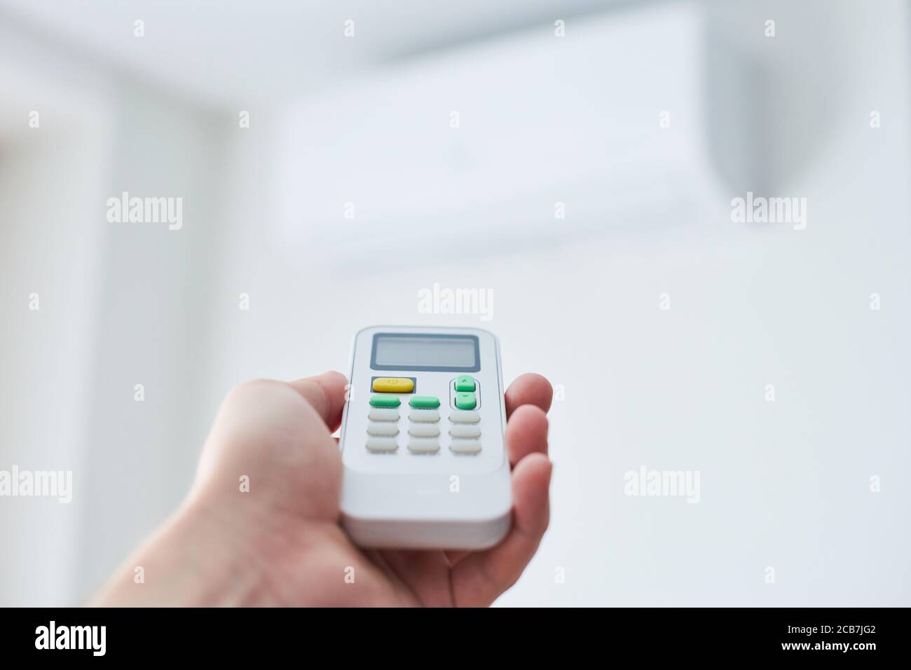 Air condition remote control. Hand with room conditioner remote control ...