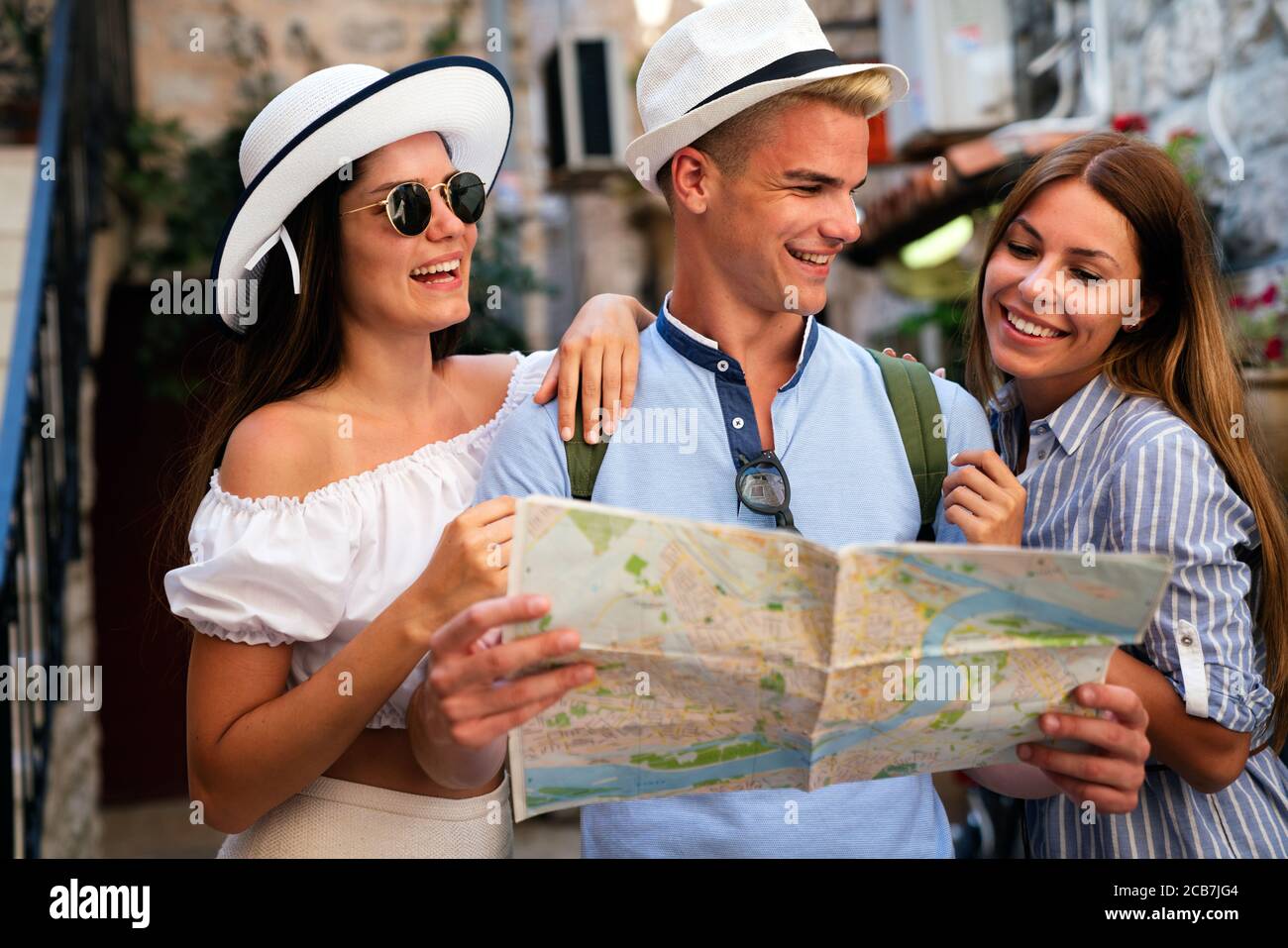Happy group of friends tourists sightseeing in city on vacation Stock ...