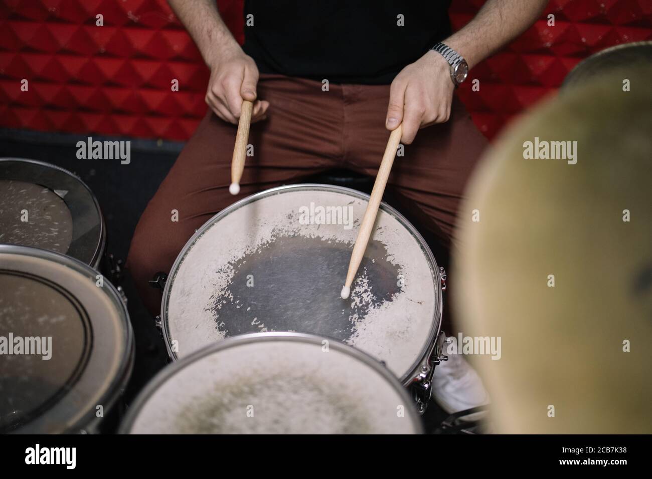 Shot of an unrecognizable man playing the drums. Cropped view of man ...